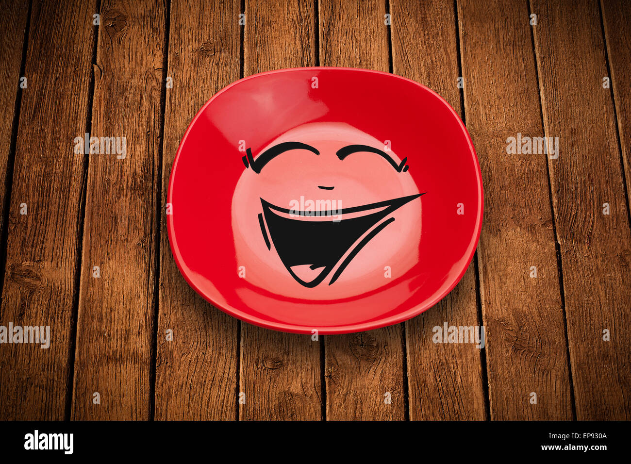 Happy smiley cartoon face on colorful dish plate Stock Photo - Alamy