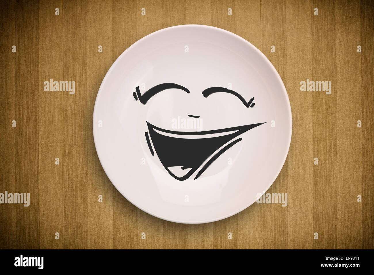 Happy smiley cartoon face on colorful dish plate Stock Photo - Alamy