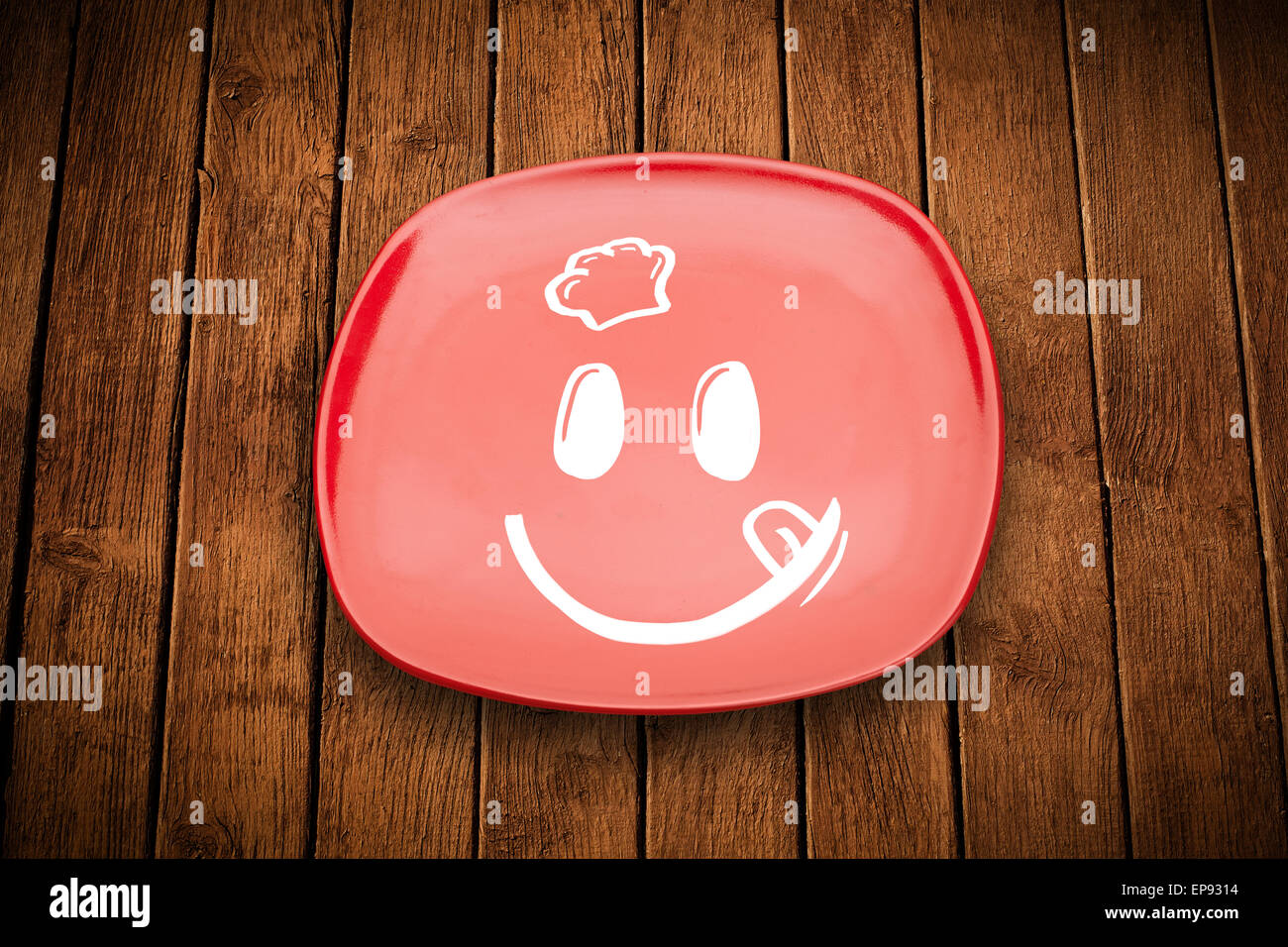 Happy smiley cartoon face on colorful dish plate Stock Photo - Alamy