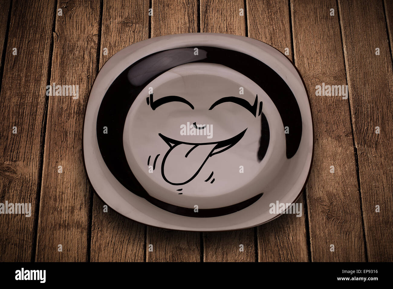 Happy smiley cartoon face on colorful dish plate Stock Photo - Alamy