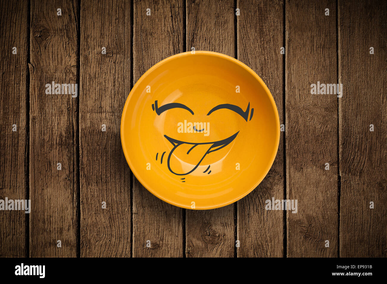 Happy smiley cartoon face on colorful dish plate Stock Photo - Alamy