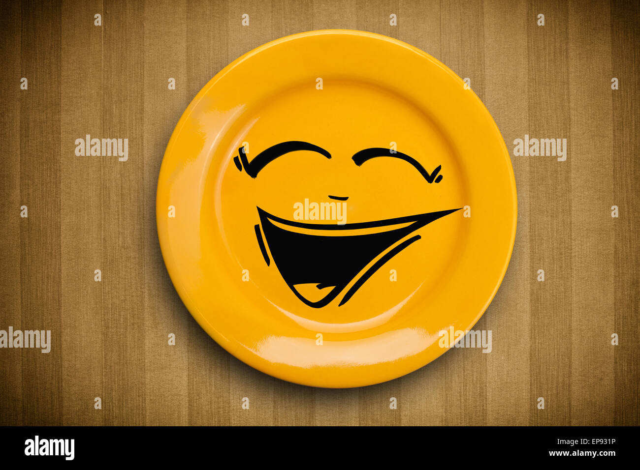 Happy smiley cartoon face on colorful dish plate Stock Photo - Alamy