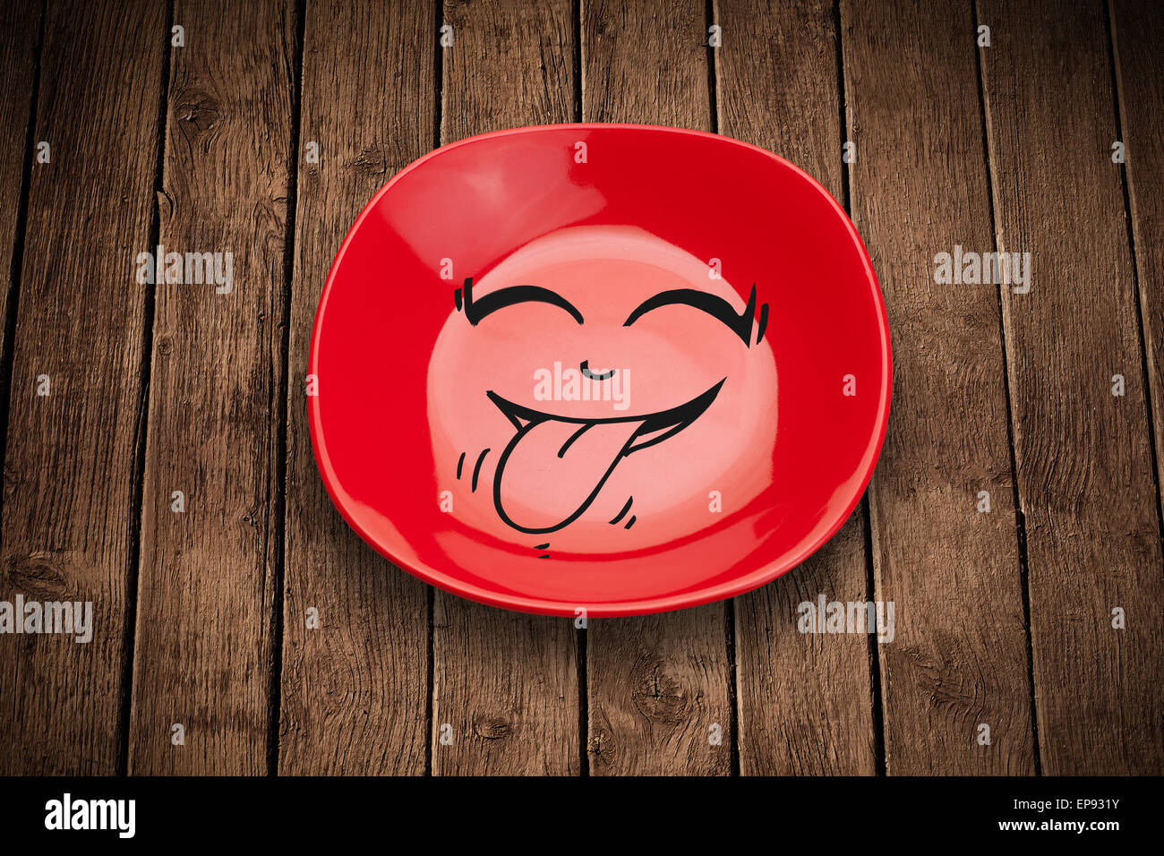 Happy smiley cartoon face on colorful dish plate Stock Photo - Alamy