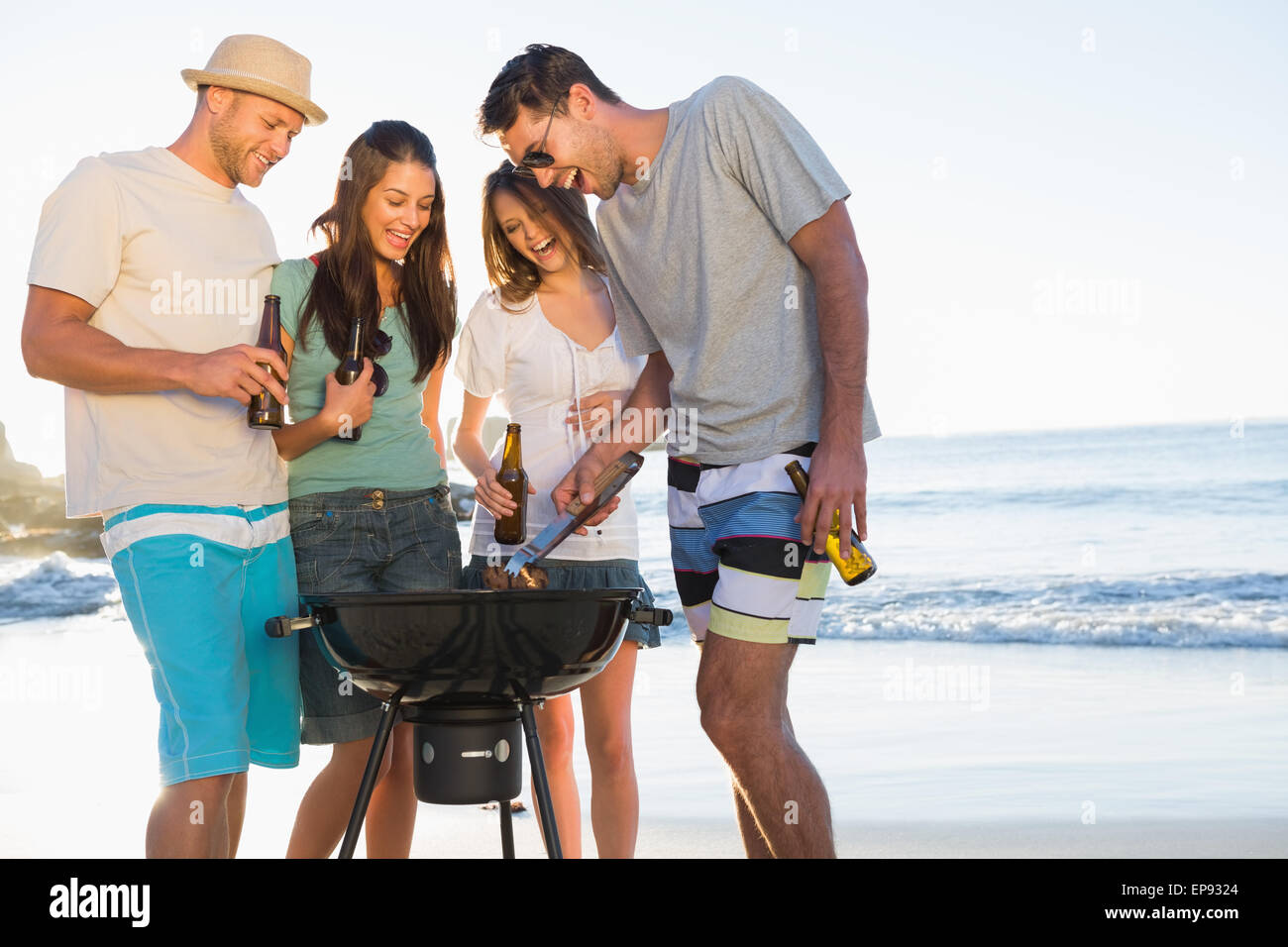 Smiling young friends having barbecue together Stock Photo - Alamy