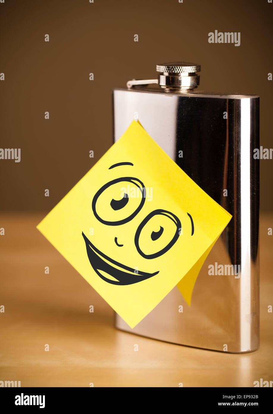 Post-it note with smiley face sticked on hip flask Stock Photo - Alamy