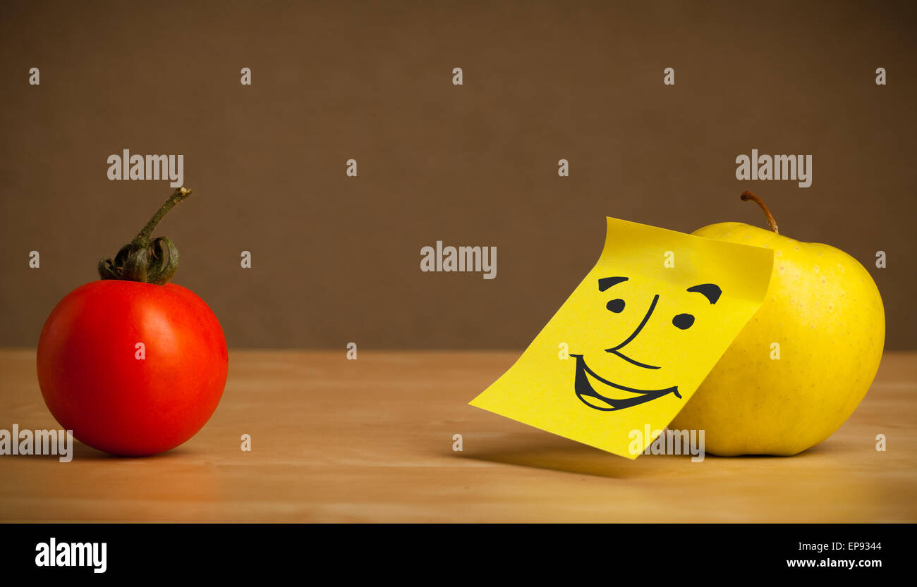 Apple with post-it note smiling at tomato Stock Photo - Alamy