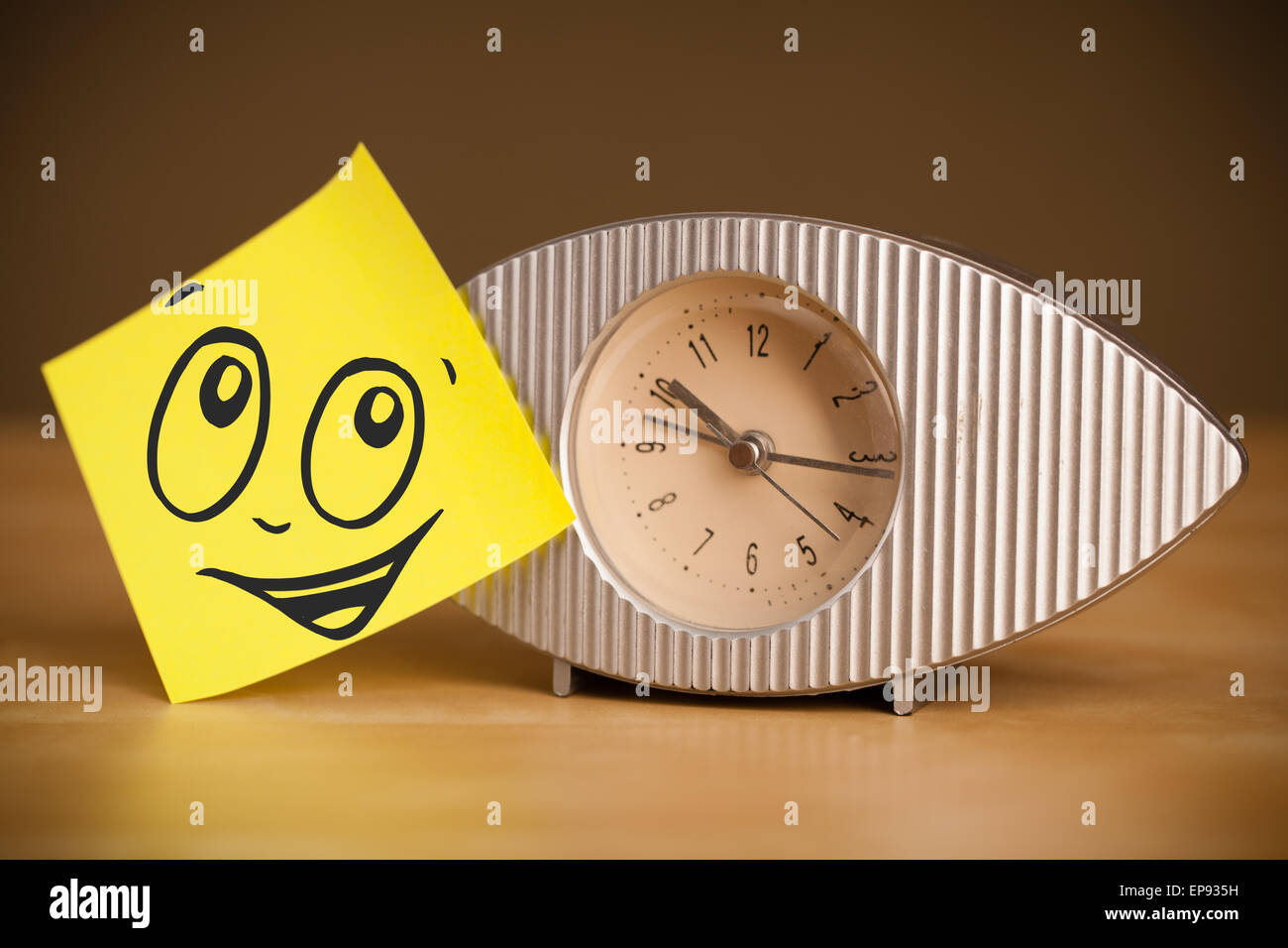 Post-it note with smiley face sticked on clock Stock Photo - Alamy