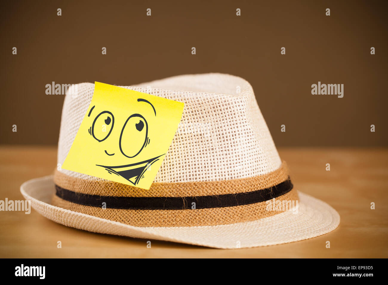 Post-it note with smiley face sticked on hat Stock Photo - Alamy
