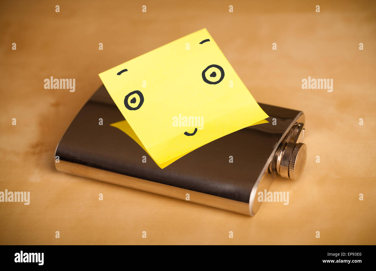 Post-it note with smiley face sticked on a hip flask Stock Photo - Alamy