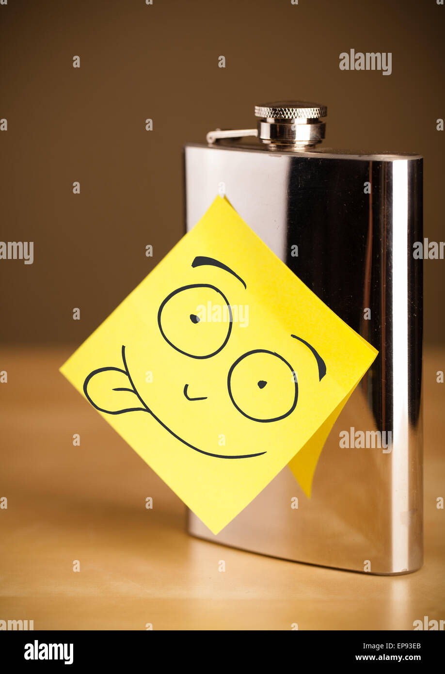 Post-it note with smiley face sticked on a hip flask Stock Photo - Alamy