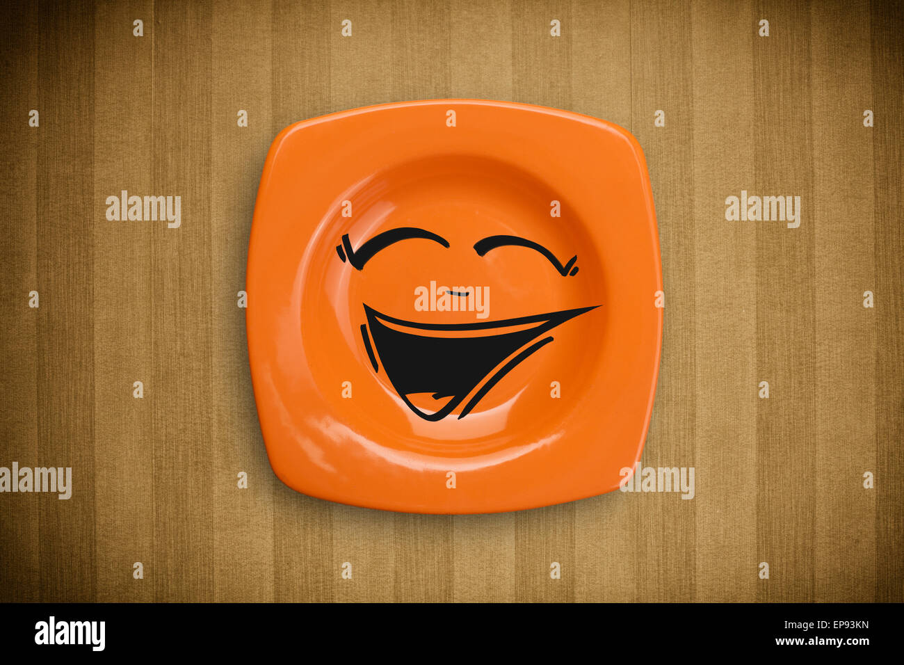 Happy smiley cartoon face on colorful dish plate Stock Photo - Alamy
