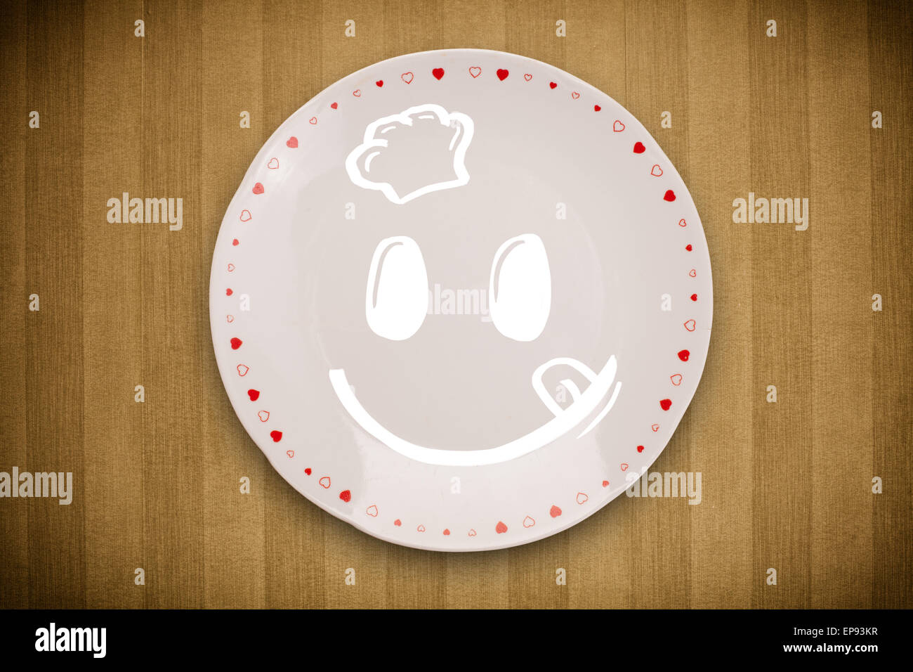 Happy smiley cartoon face on colorful dish plate Stock Photo - Alamy