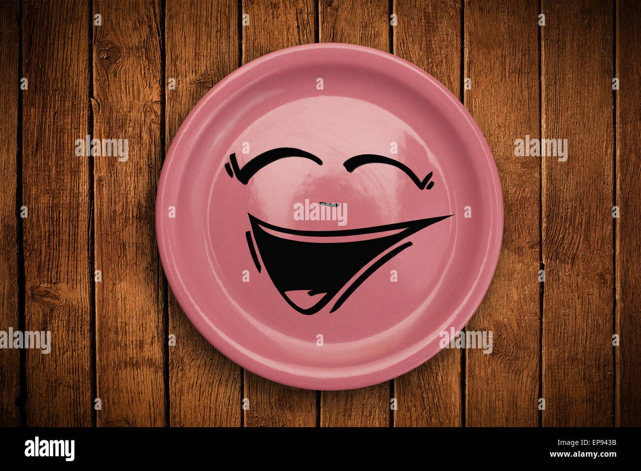 Happy smiley cartoon face on colorful dish plate Stock Photo - Alamy