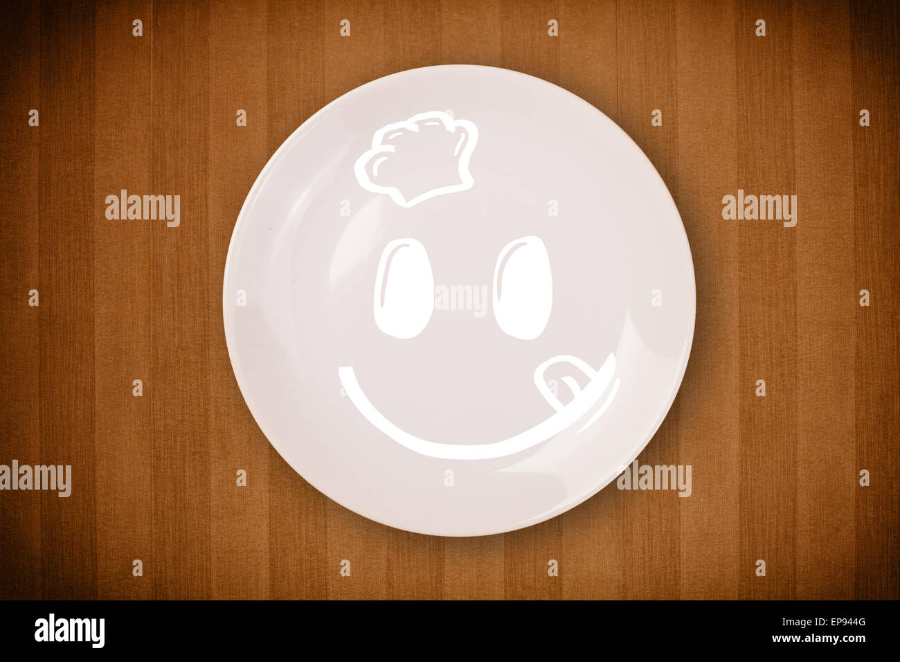 Happy smiley cartoon face on colorful dish plate Stock Photo - Alamy