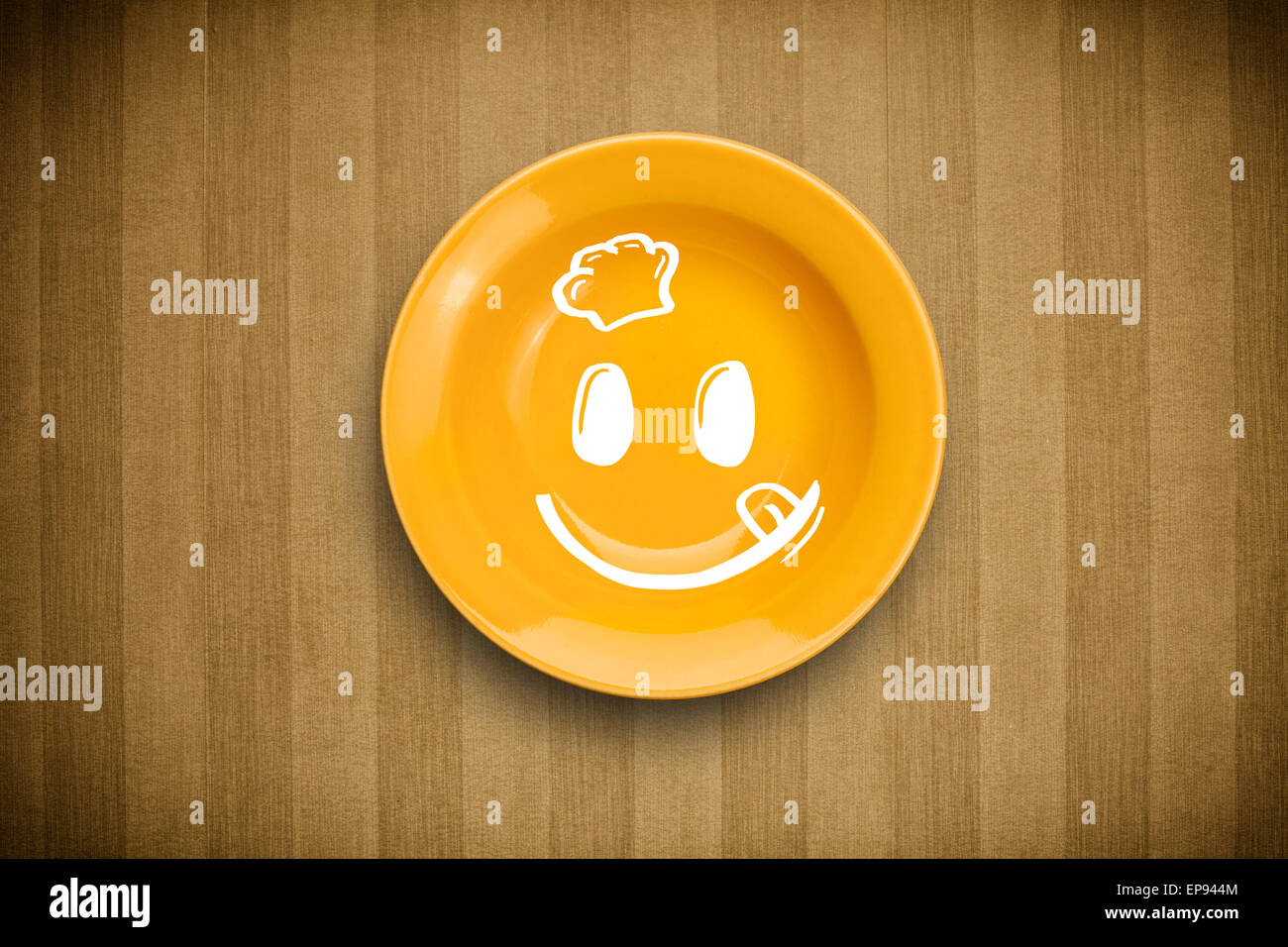 Happy smiley cartoon face on colorful dish plate Stock Photo - Alamy