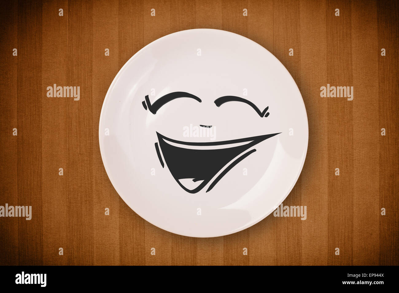Happy smiley cartoon face on colorful dish plate Stock Photo - Alamy