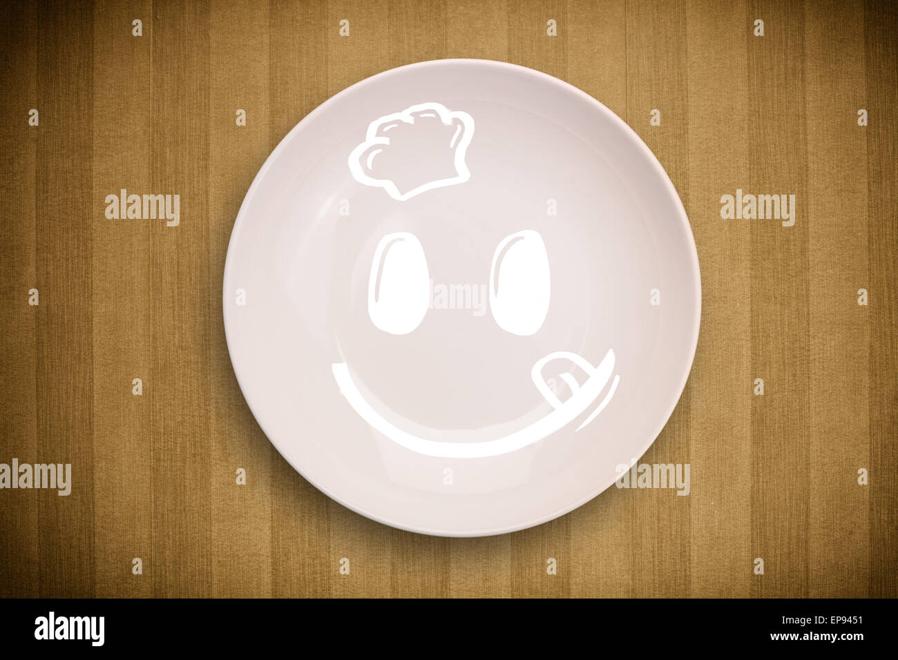 Happy smiley cartoon face on colorful dish plate Stock Photo - Alamy