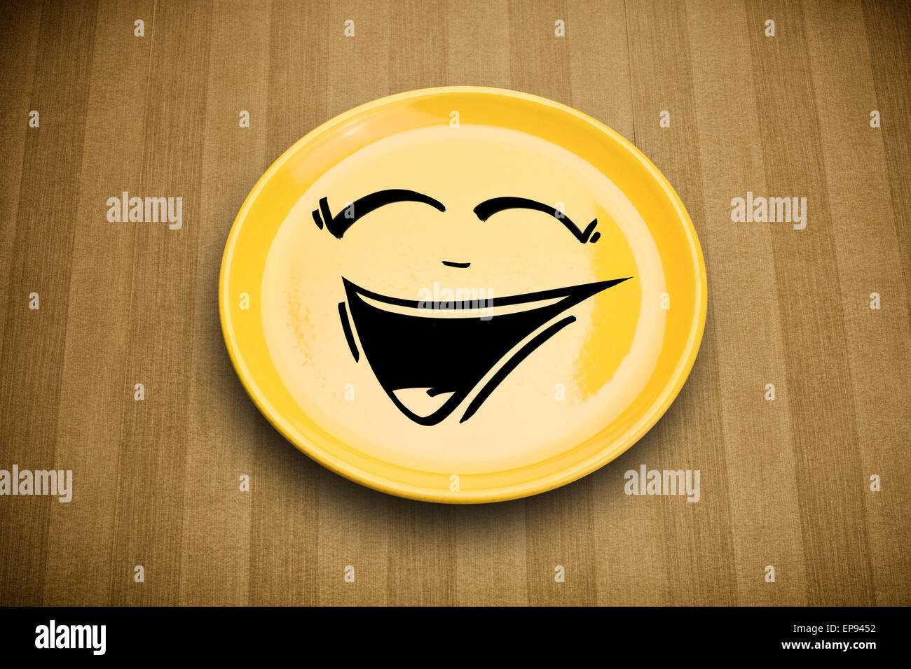 Happy smiley cartoon face on colorful dish plate Stock Photo - Alamy