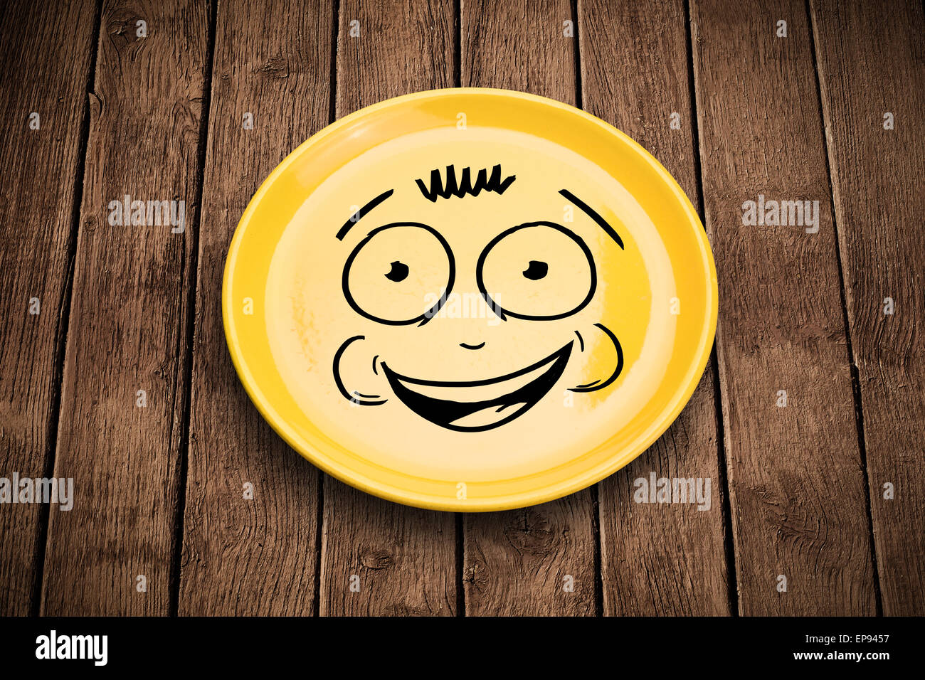 Happy smiley cartoon face on colorful dish plate Stock Photo - Alamy