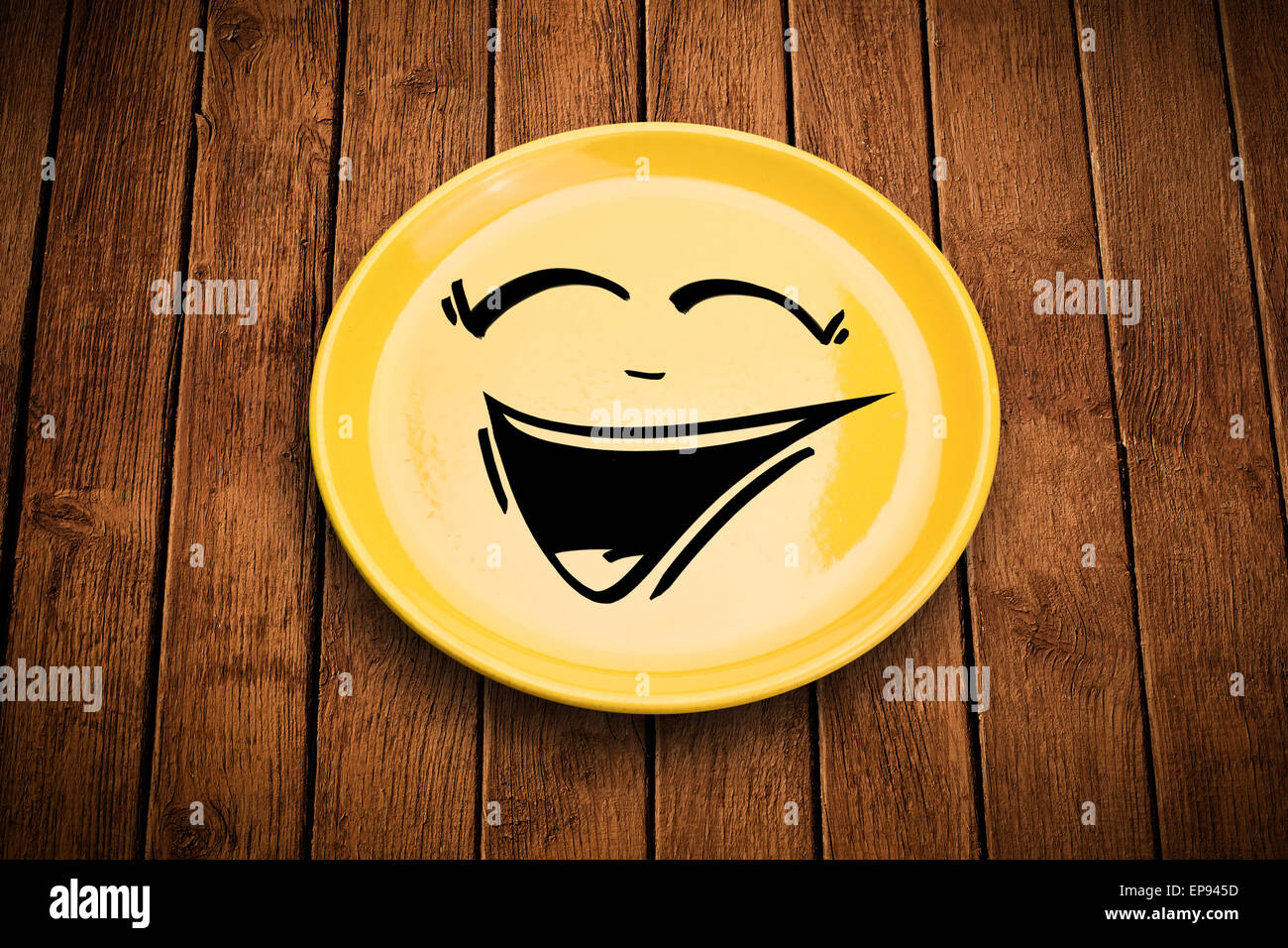 Happy smiley cartoon face on colorful dish plate Stock Photo - Alamy