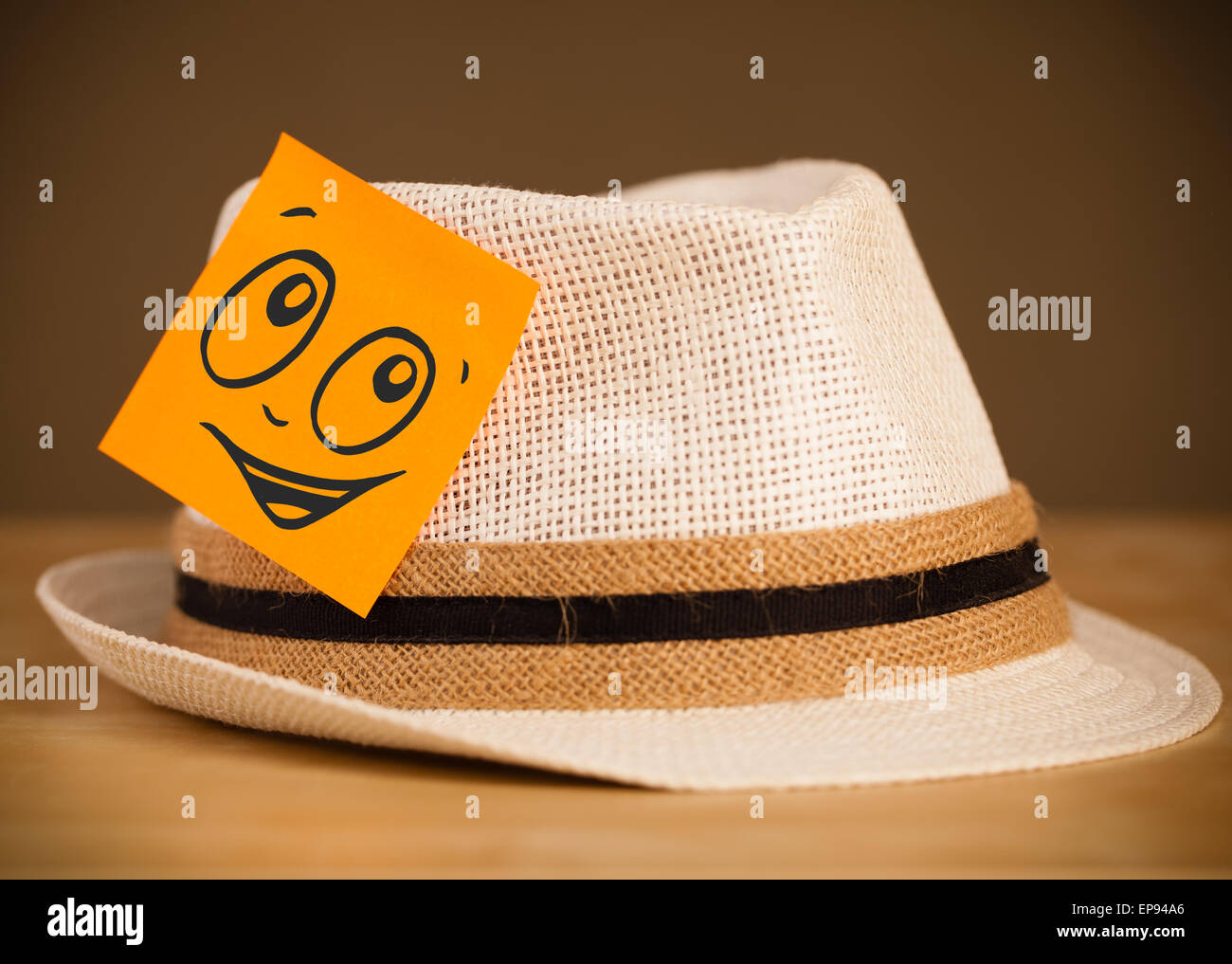 Post-it note with smiley face sticked on hat Stock Photo - Alamy