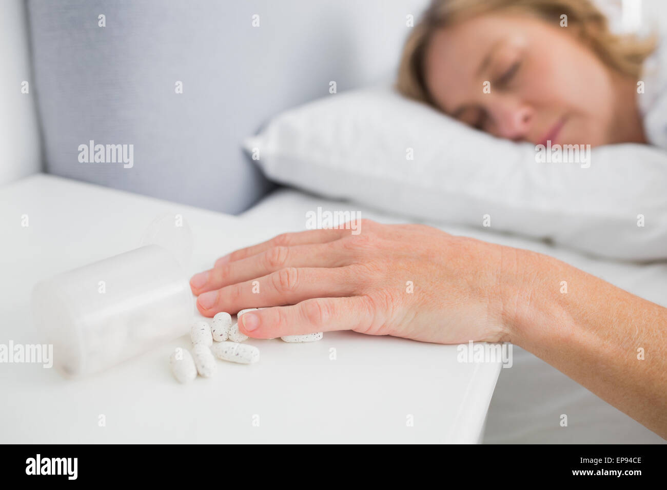 Blonde woman lying motionless after overdose of medication Stock Photo ...