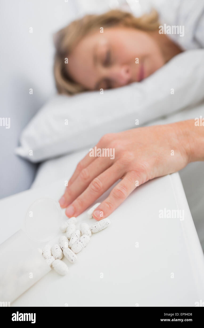 Blonde woman lying motionless after overdose of pills Stock Photo - Alamy