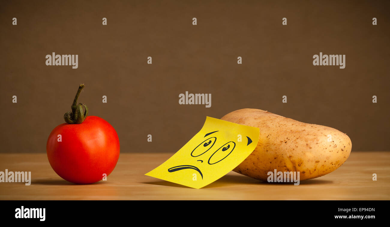 Potato with sticky post-it note looking sadly at tomato Stock Photo - Alamy