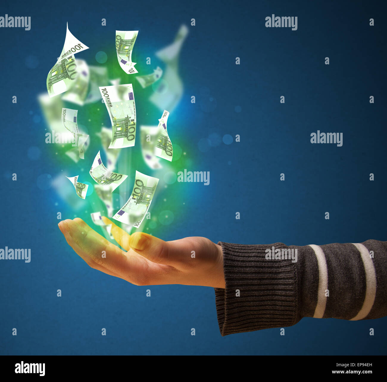 Glowing money in the hand of a woman Stock Photo - Alamy