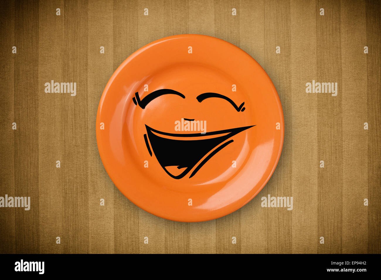 Happy smiley cartoon face on colorful dish plate Stock Photo - Alamy