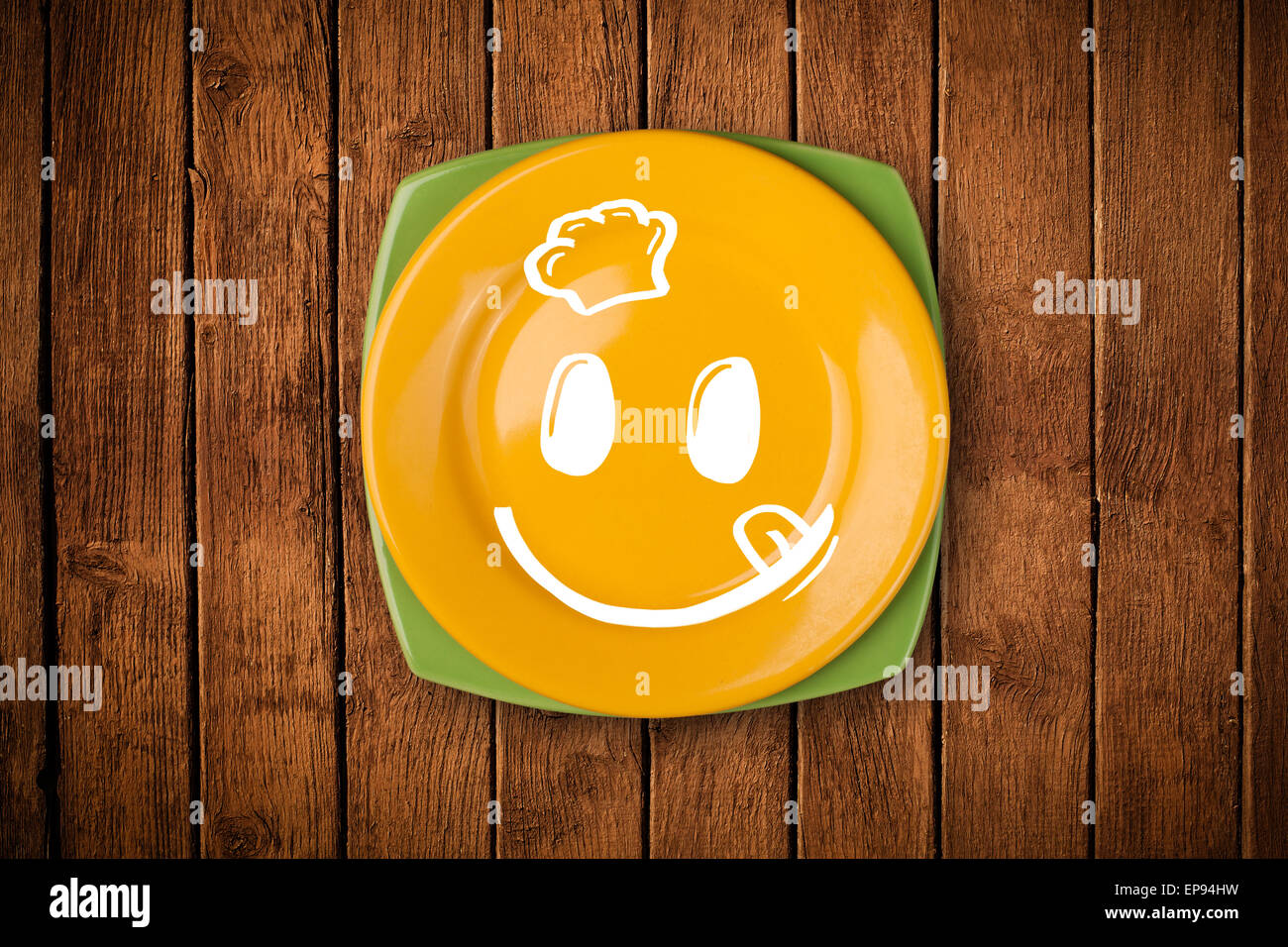 Happy smiley cartoon face on colorful dish plate Stock Photo - Alamy