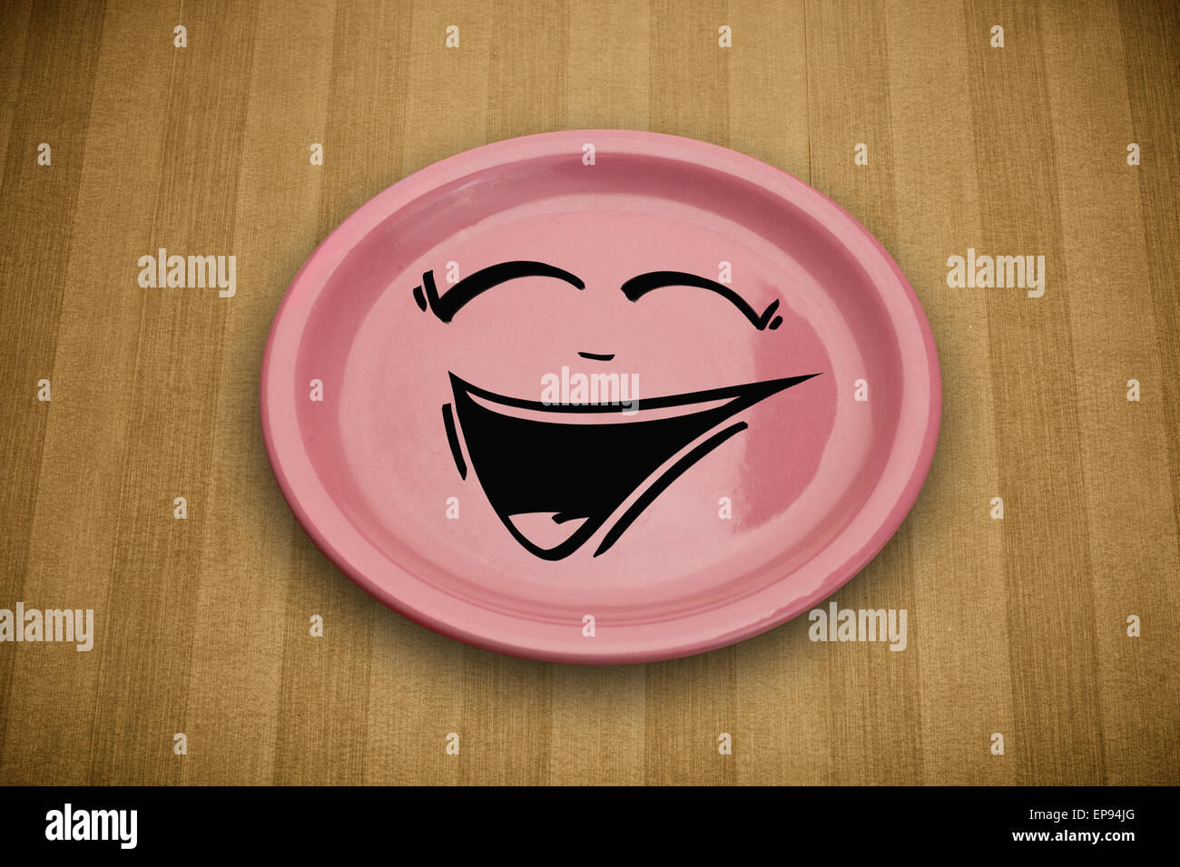 Happy smiley cartoon face on colorful dish plate Stock Photo - Alamy