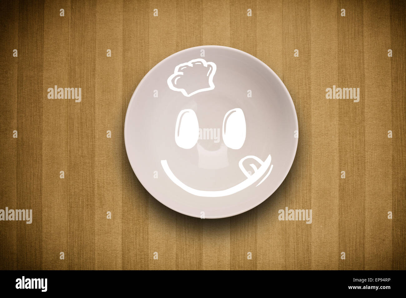 Happy smiley cartoon face on colorful dish plate Stock Photo - Alamy