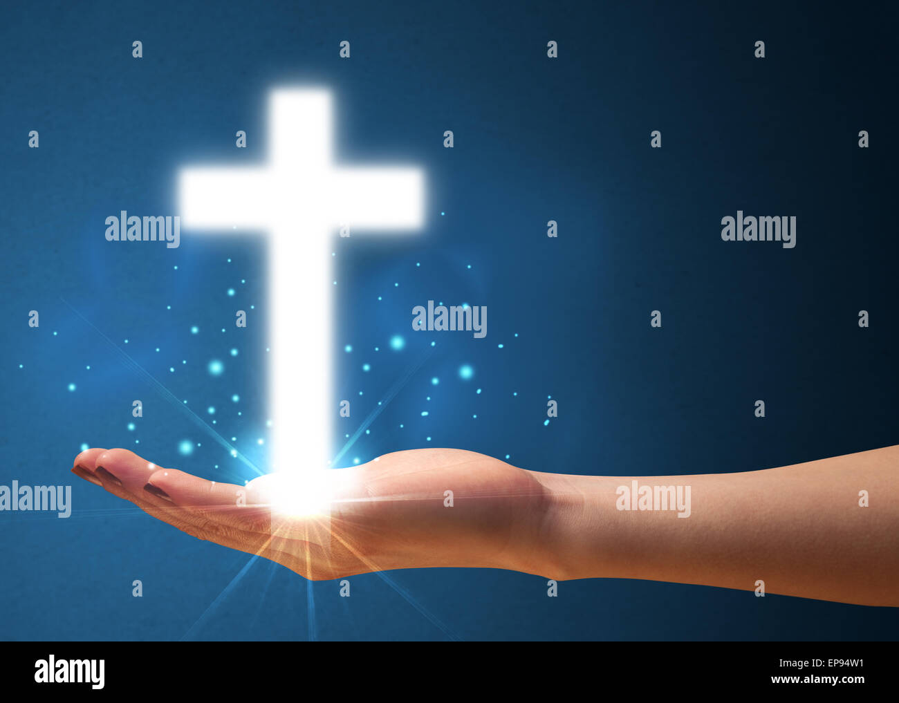 Glowing cross in the hand of a woman Stock Photo - Alamy