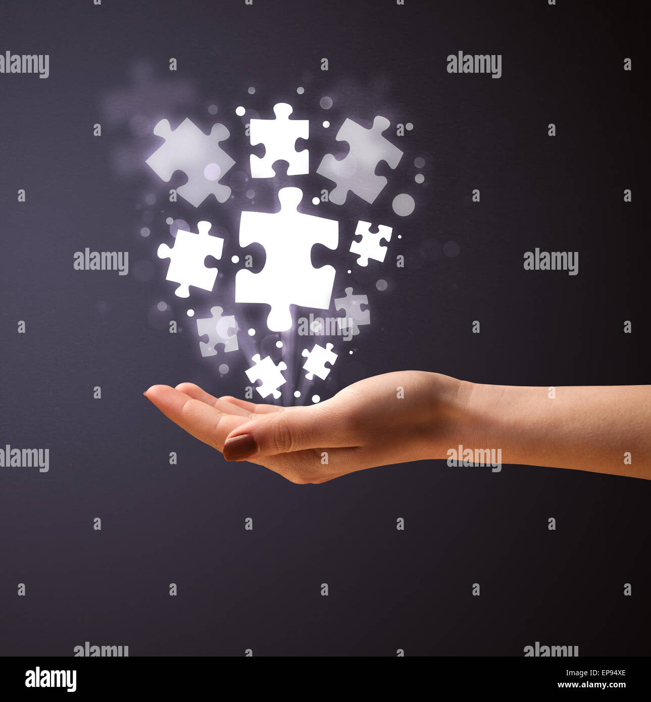 Puzzle pieces in the hand of a woman Stock Photo - Alamy