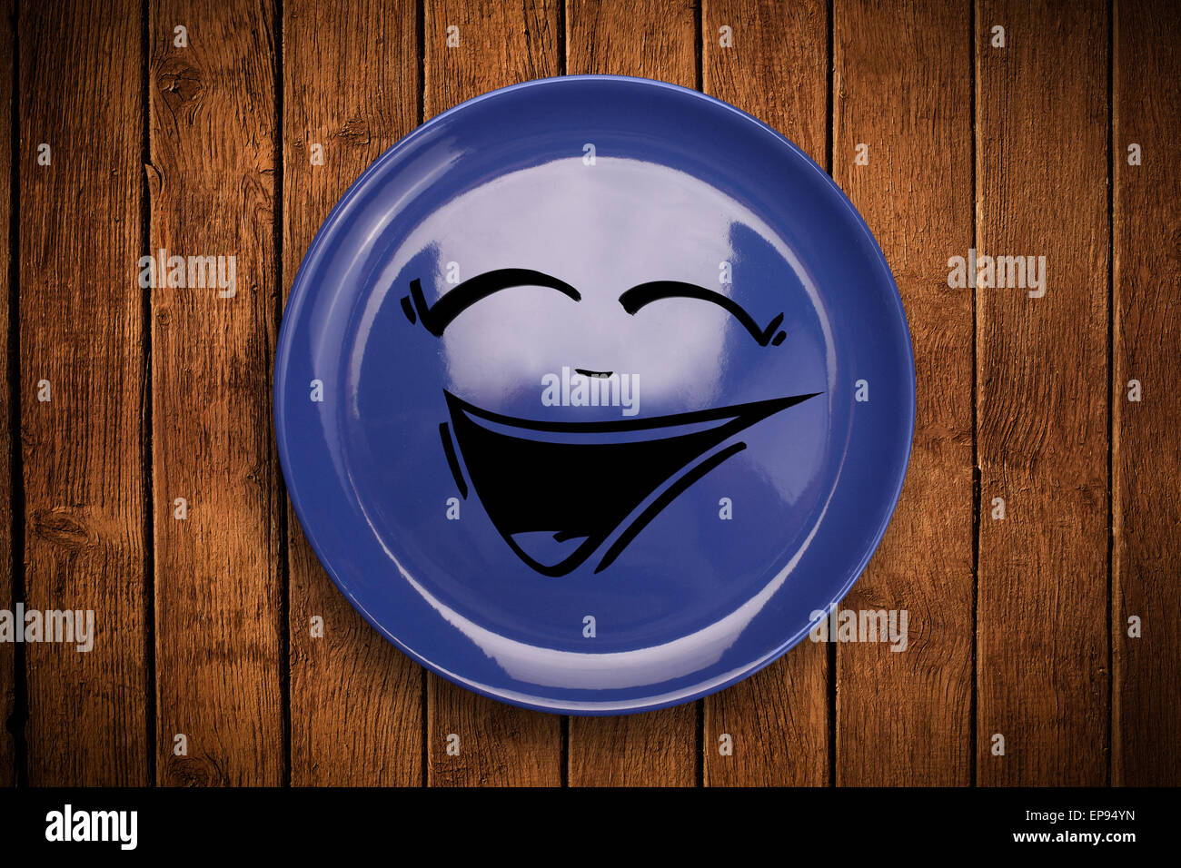 Happy smiley cartoon face on colorful dish plate Stock Photo - Alamy