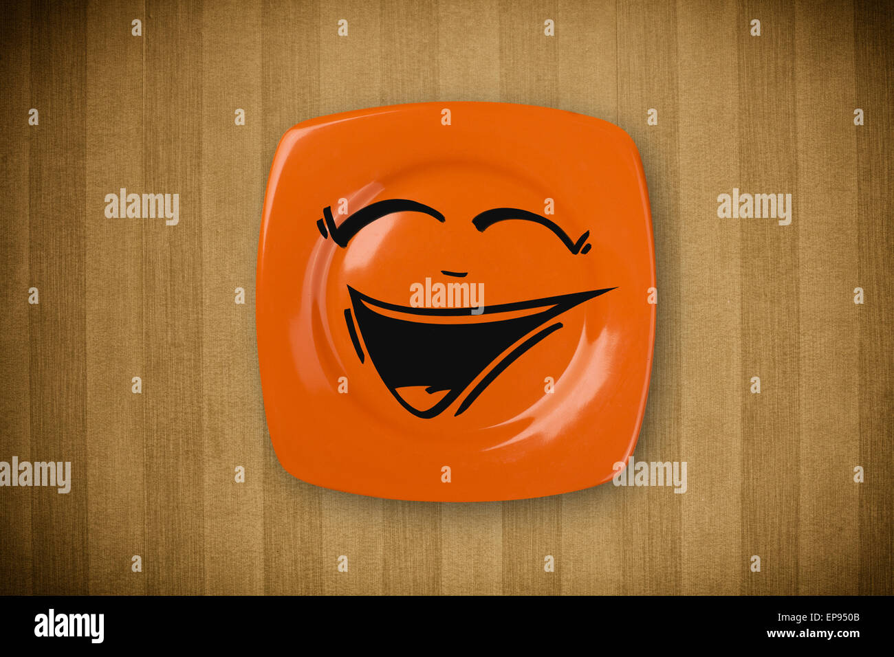 Happy smiley cartoon face on colorful dish plate Stock Photo - Alamy