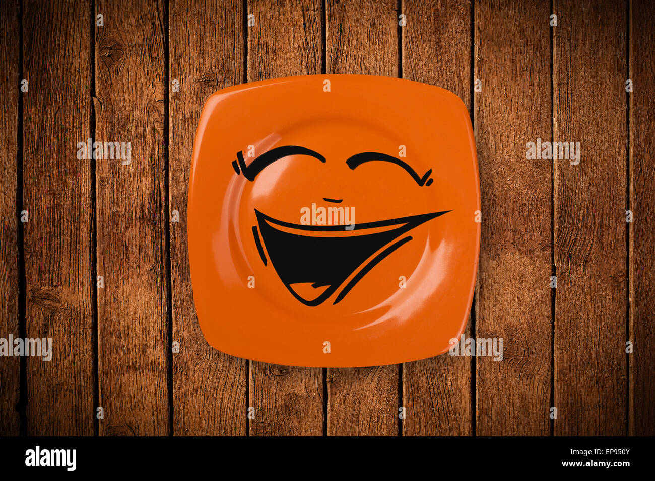 Happy smiley cartoon face on colorful dish plate Stock Photo - Alamy