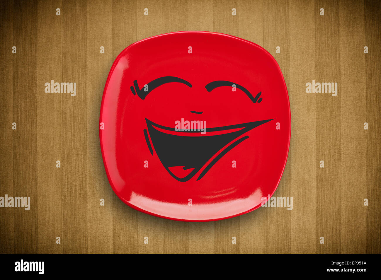 Happy smiley cartoon face on colorful dish plate Stock Photo - Alamy