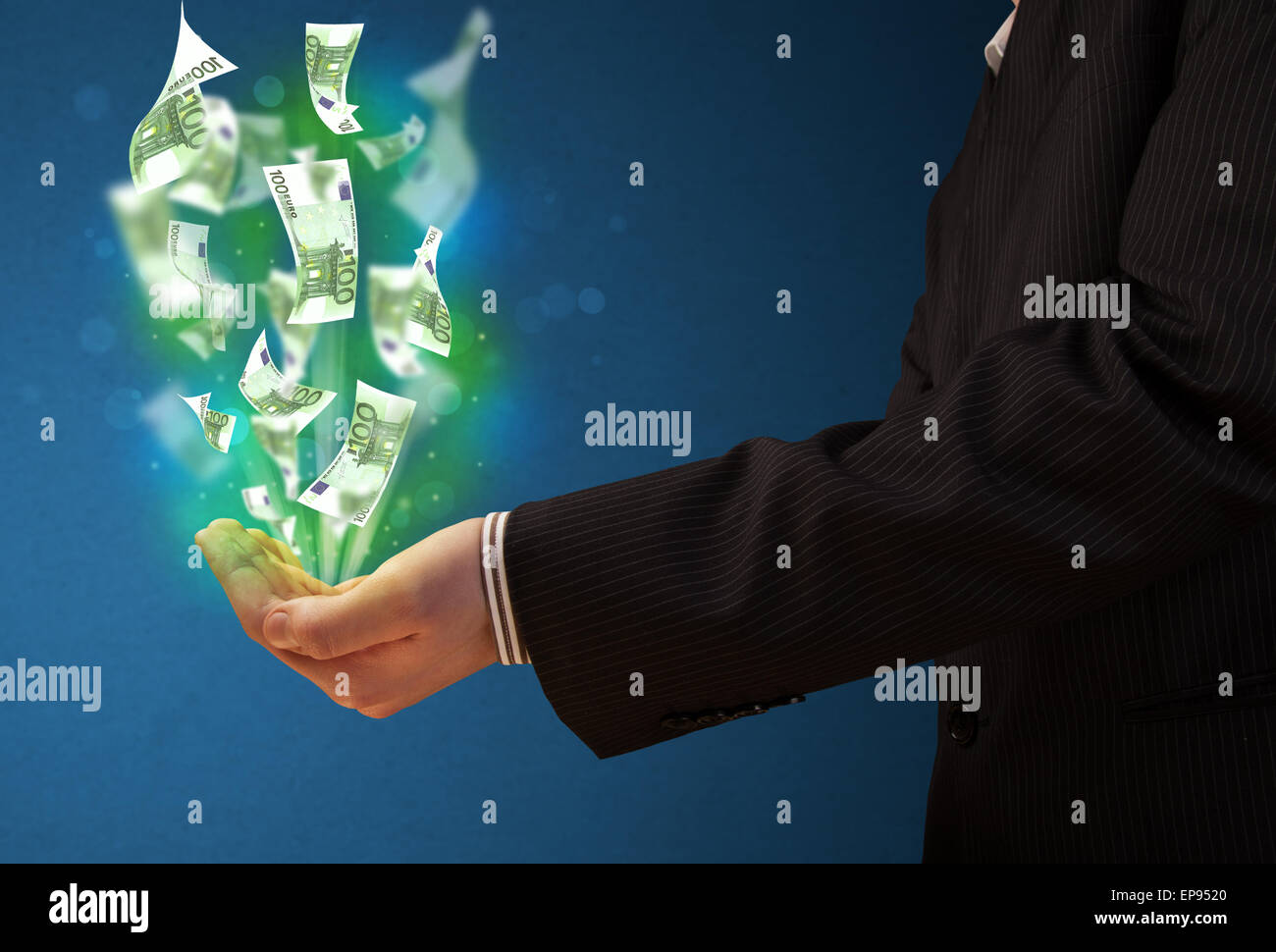 Glowing money in the hand of a businessman Stock Photo - Alamy