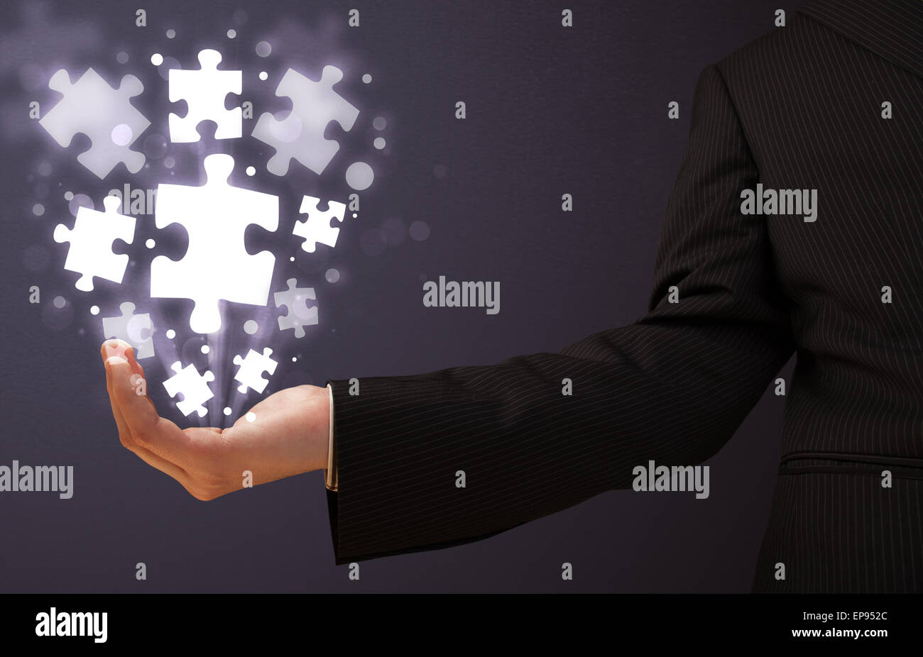 Puzzle pieces in the hand of a businessman Stock Photo - Alamy
