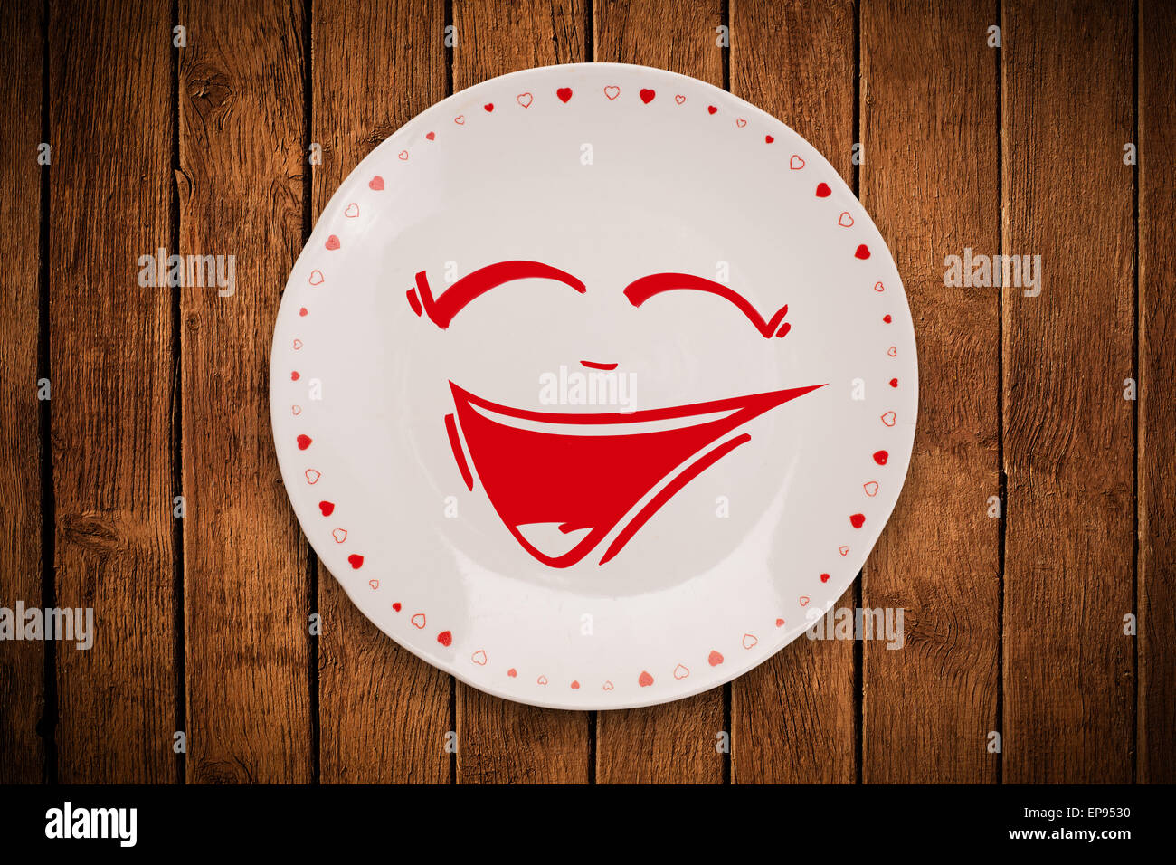 Happy smiley cartoon face on colorful dish plate Stock Photo - Alamy