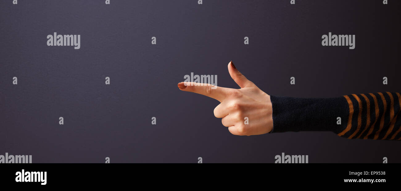 Gun shaped woman hand Stock Photo - Alamy