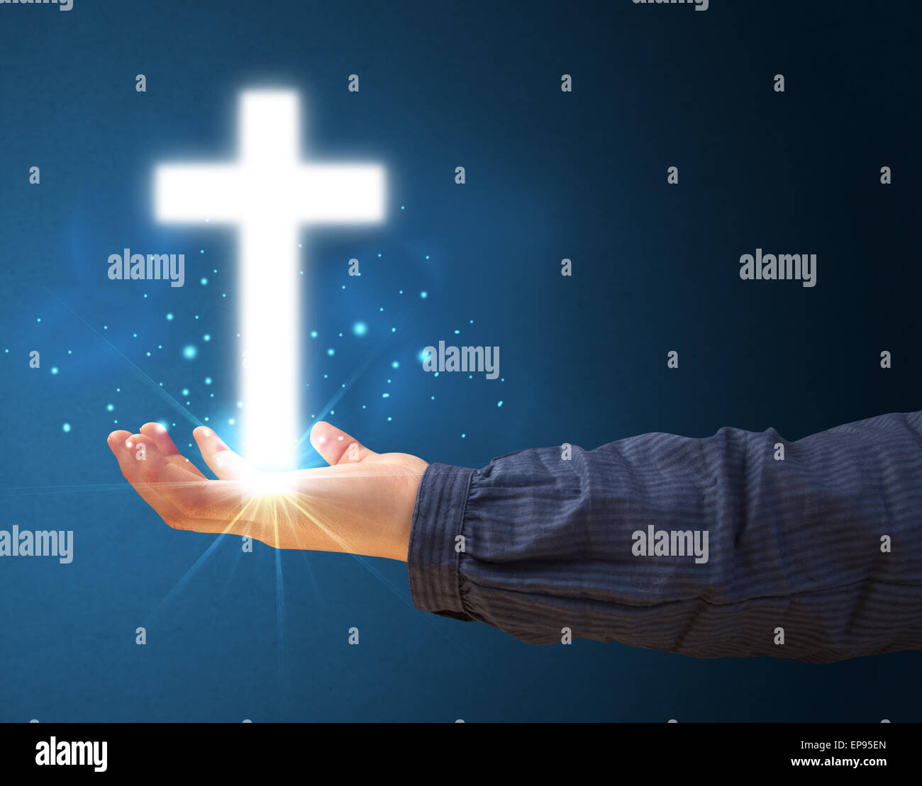 Glowing cross in the hand of a woman Stock Photo - Alamy