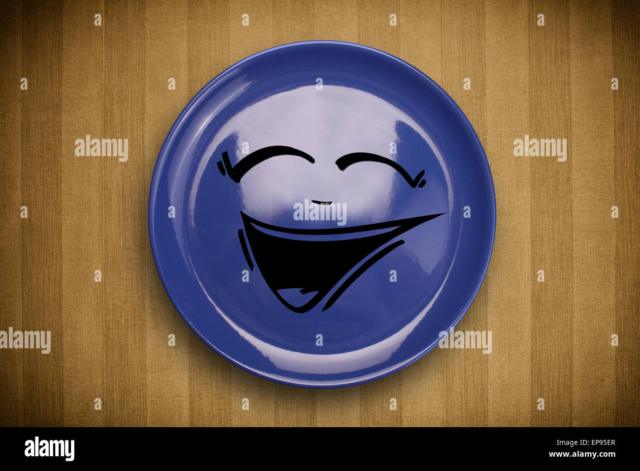 Happy smiley cartoon face on colorful dish plate Stock Photo - Alamy