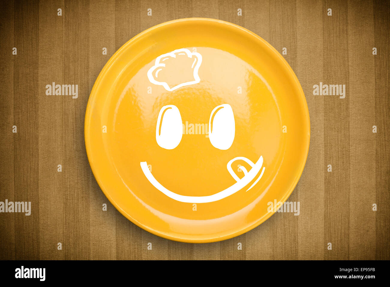 Happy smiley cartoon face on colorful dish plate Stock Photo - Alamy