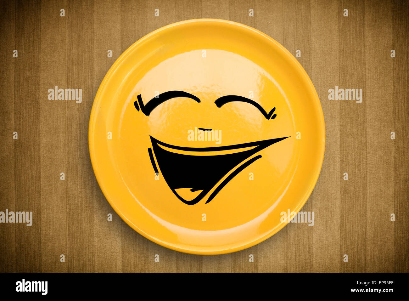 Happy smiley cartoon face on colorful dish plate Stock Photo - Alamy
