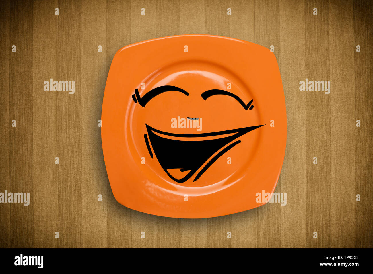 Happy smiley cartoon face on colorful dish plate Stock Photo - Alamy