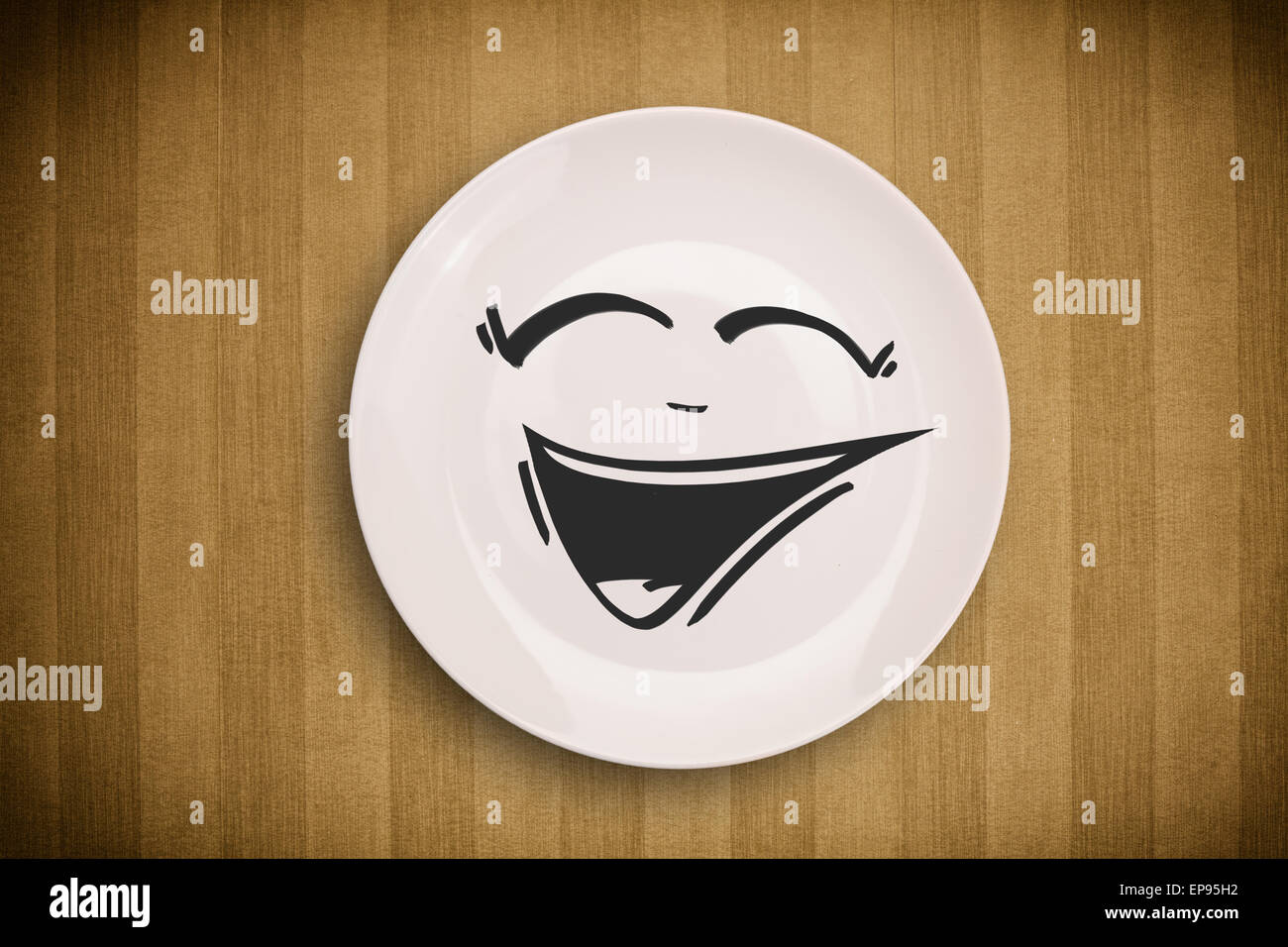 Happy smiley cartoon face on colorful dish plate Stock Photo - Alamy