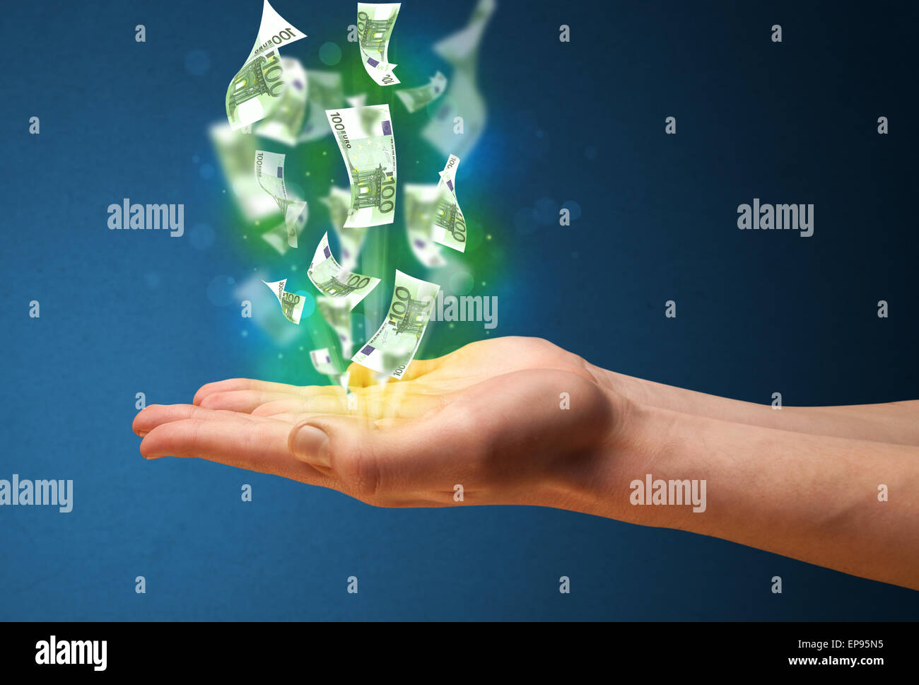 Glowing money in the hand of a businessman Stock Photo - Alamy